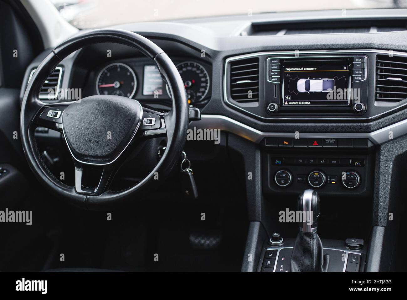 Car interior luxury steering wheel. Dashboard, climate control, display ...