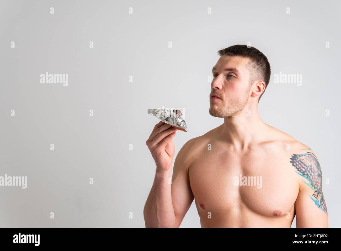 Man eats protein bar on white background isolated bar energy eat ...
