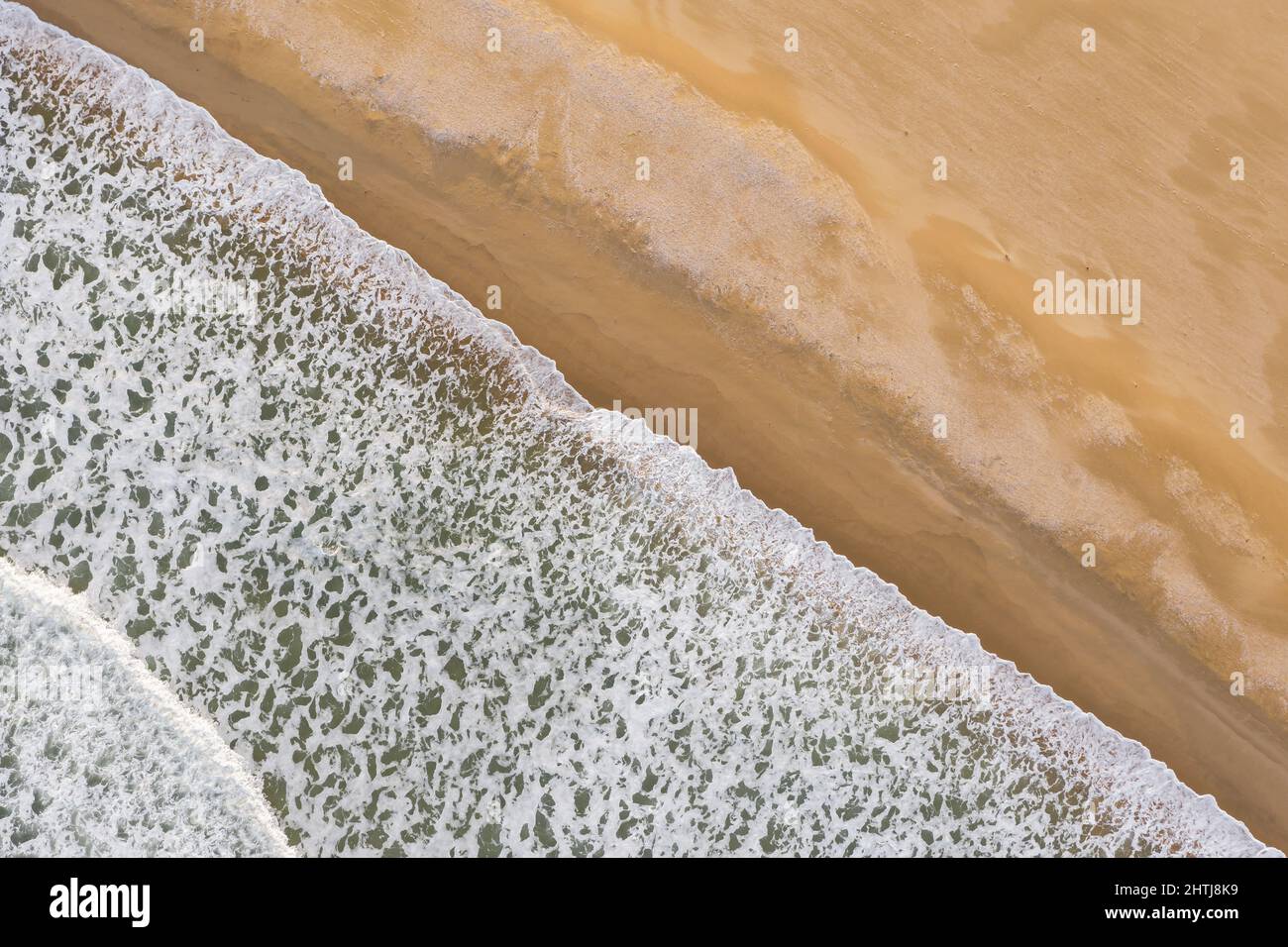 Aerial view of waves crash to beach Stock Photo - Alamy