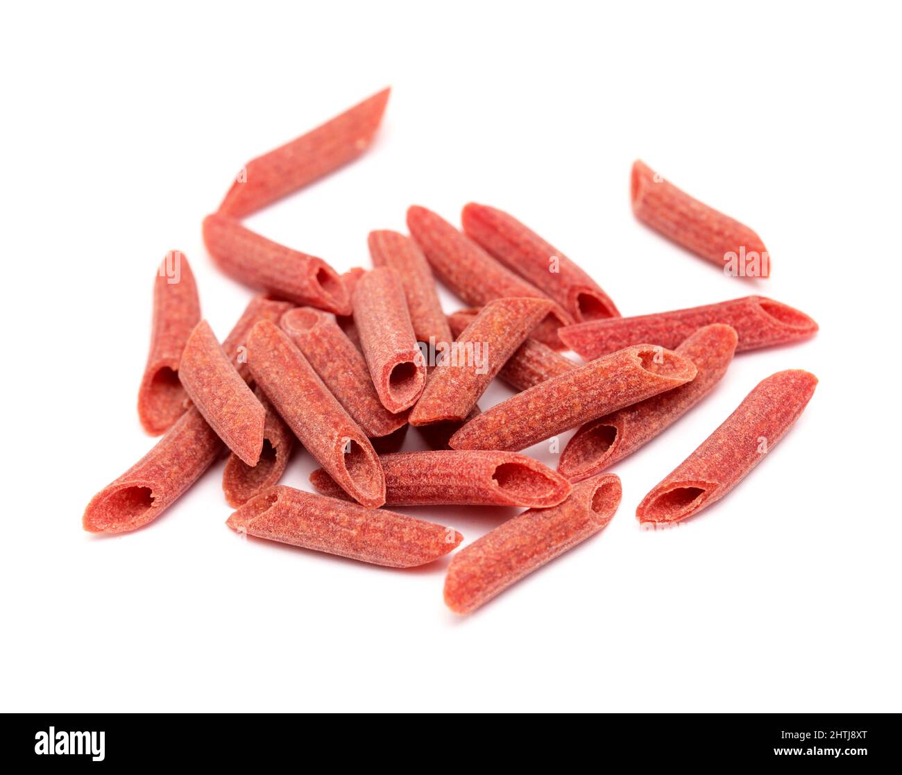 Dry Penne pasta with natural red beetroot coloring isolated on white ...