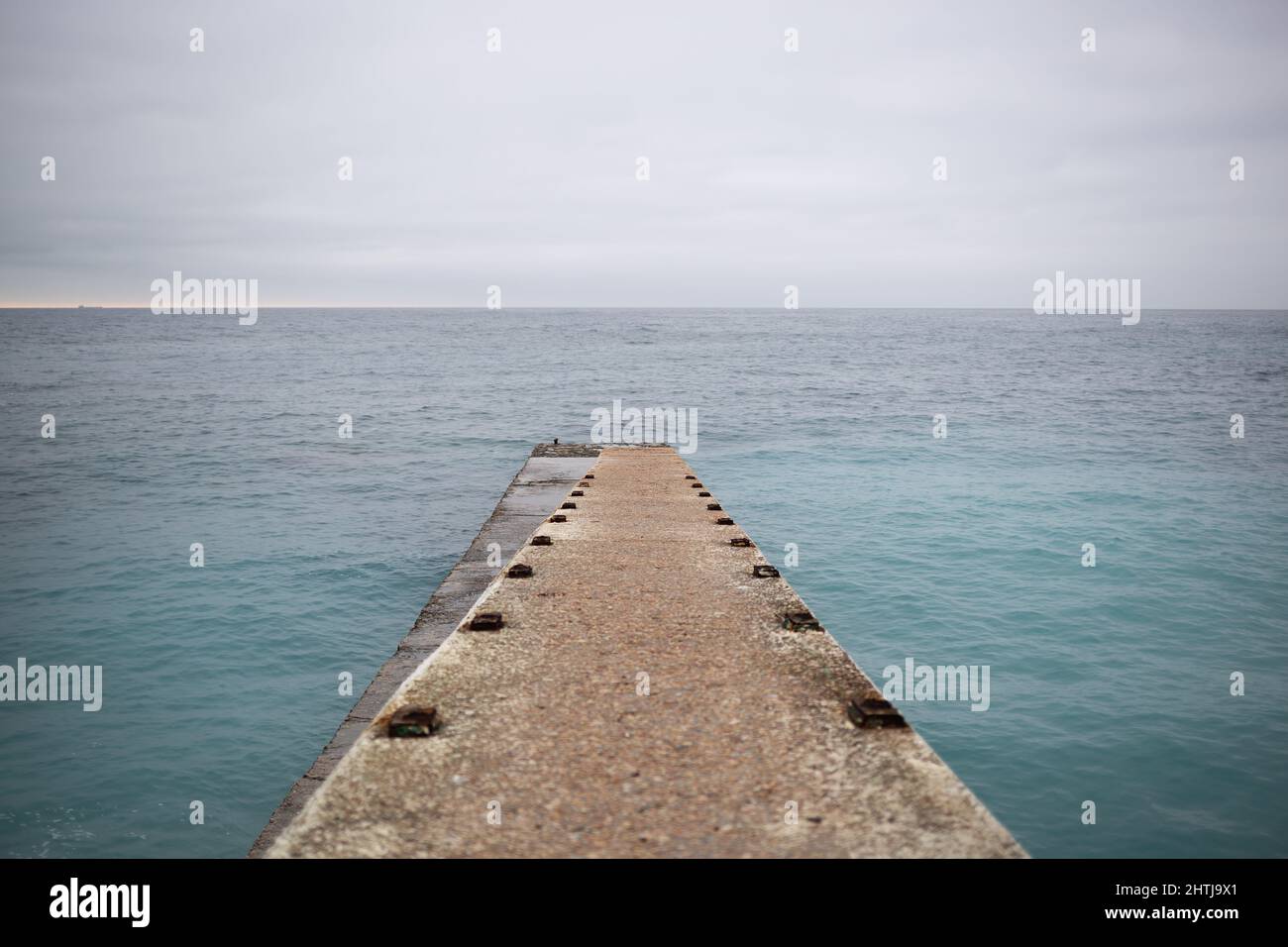 a pier that splits into two at the end and goes out to sea Stock Photo ...