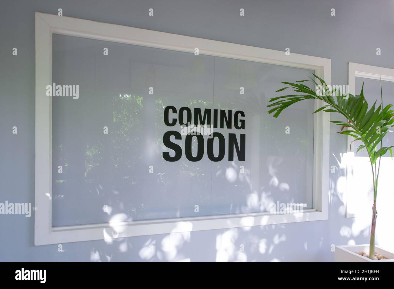 Shop Window with Coming Soon Sign extreme closeup Stock Photo - Alamy