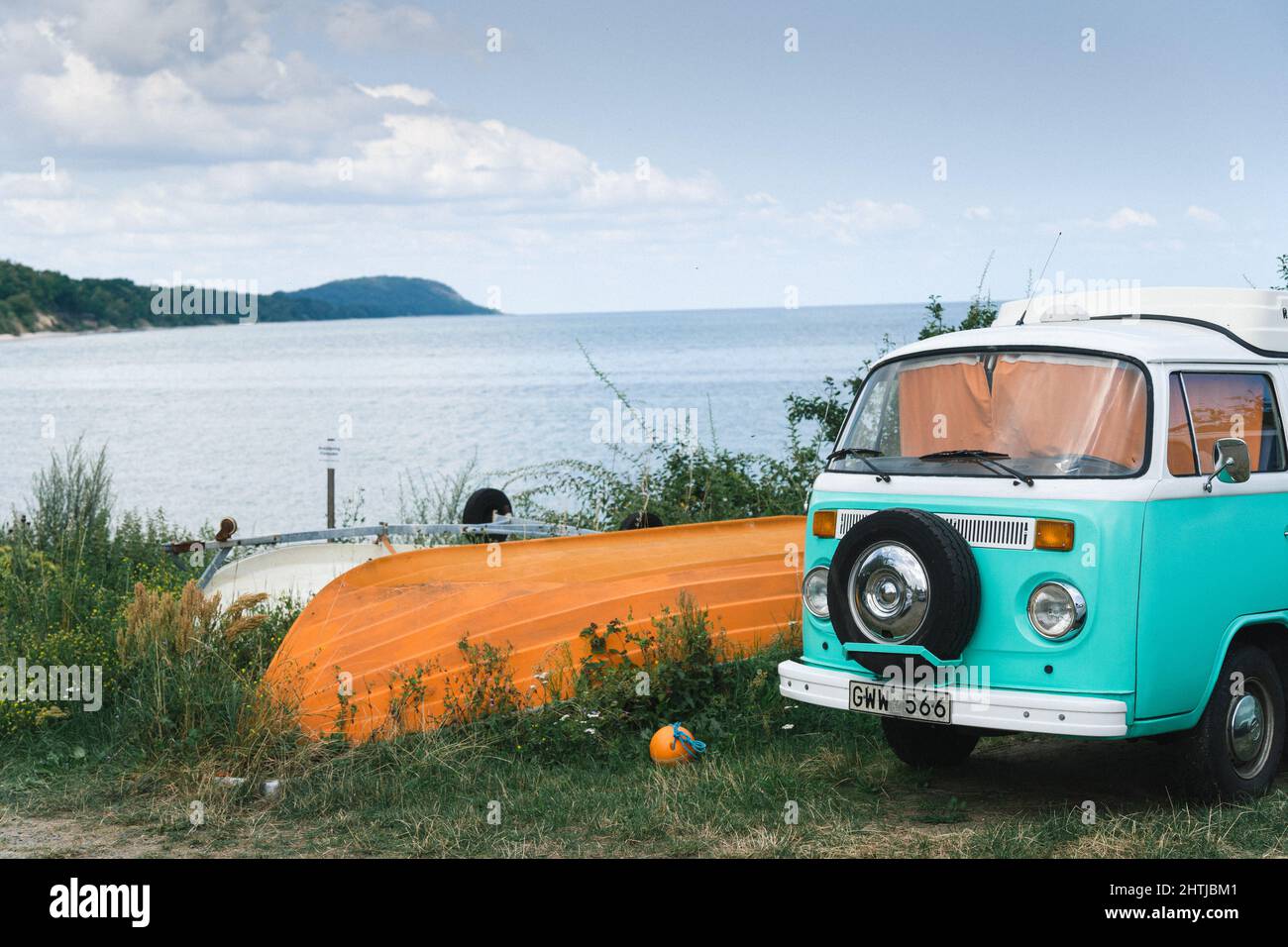 Turquoise VW camping bus next to an orange boat in Sweden Stock Photo ...