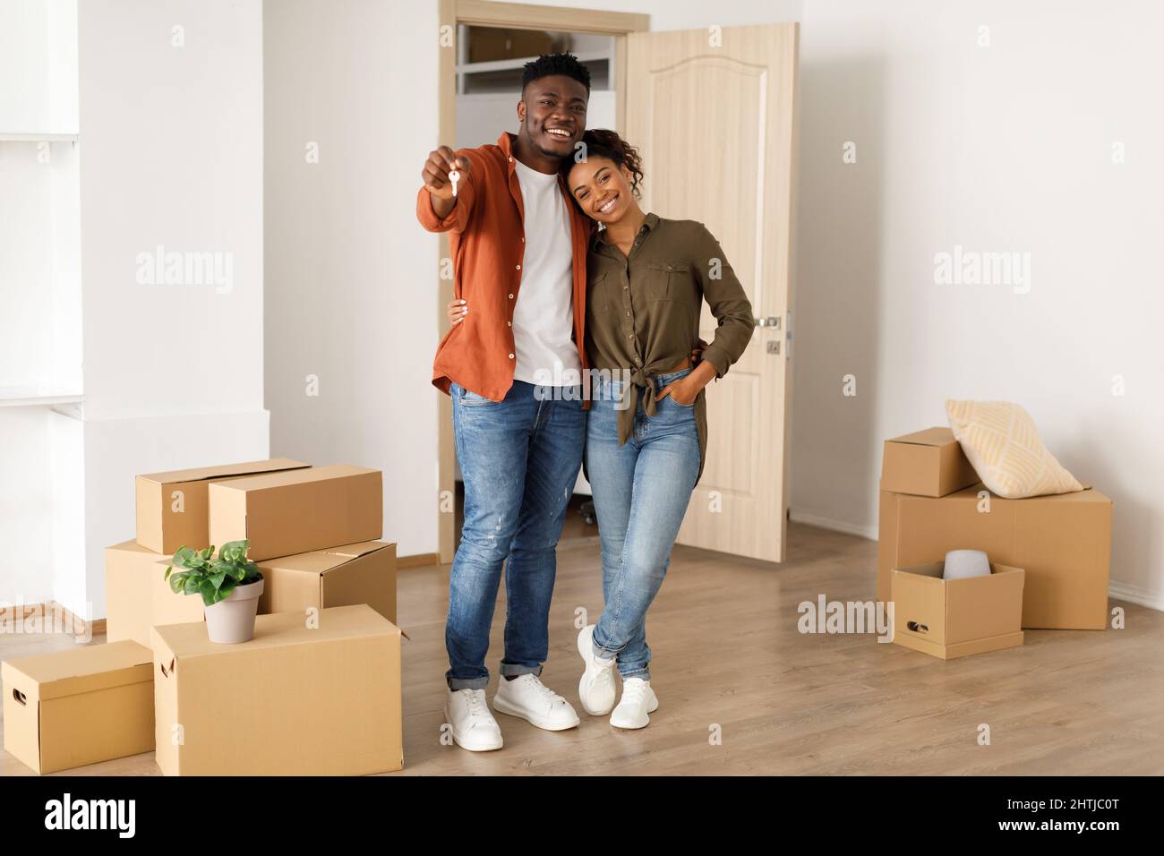 Happy African Spouses Showing Key Standing Among Moving Boxes Indoor ...