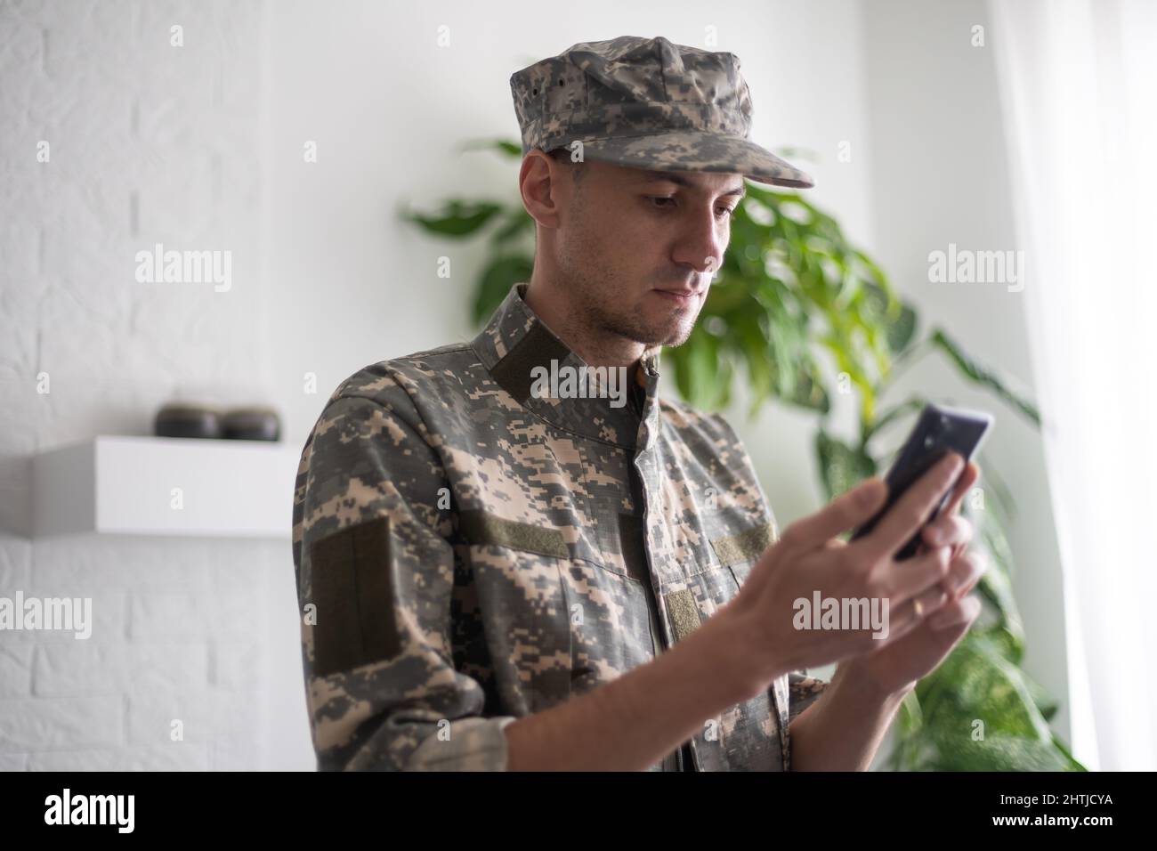 military man with phone, cyber police, information war Stock Photo - Alamy