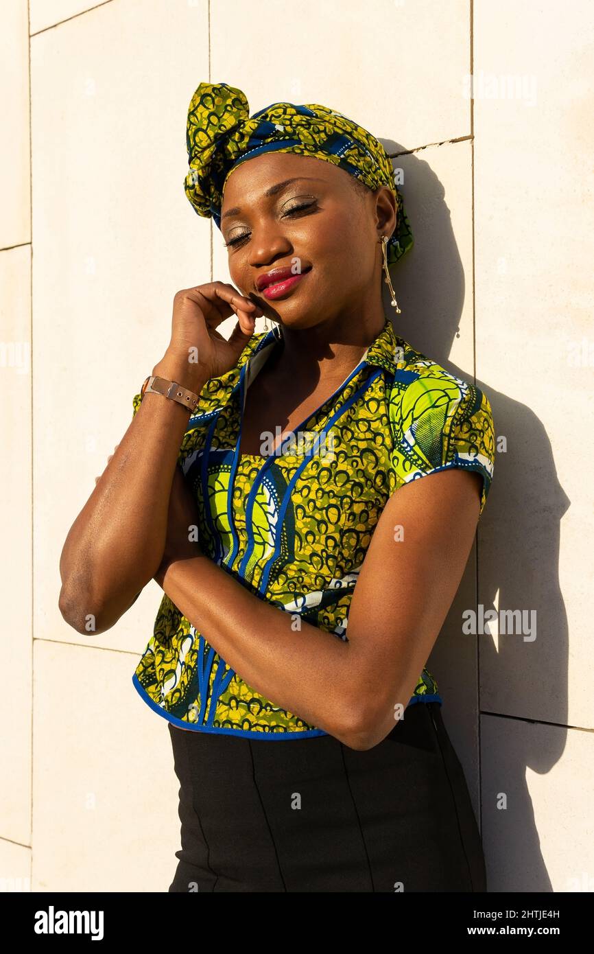 Dreamy elegant African female model in traditional turban and dress ...