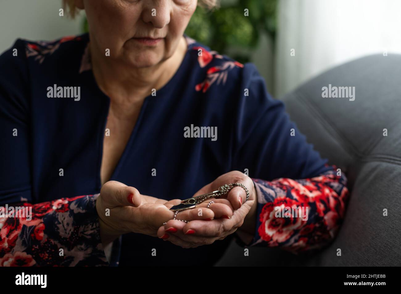 elderly woman holding in hand military token Stock Photo - Alamy