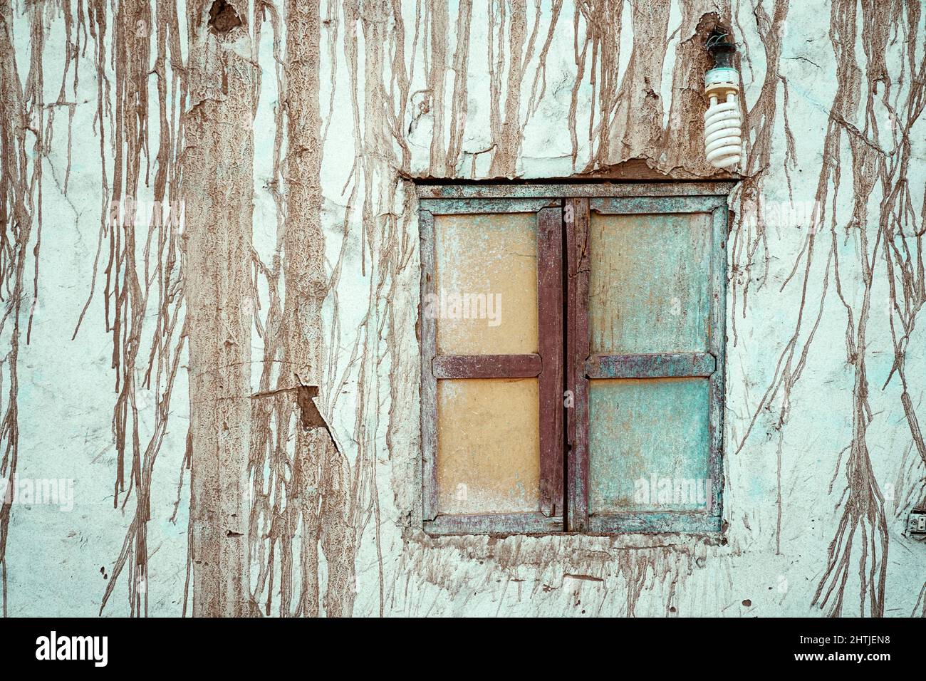 Full frame of weathered white wall of old neglected building with lamp ...