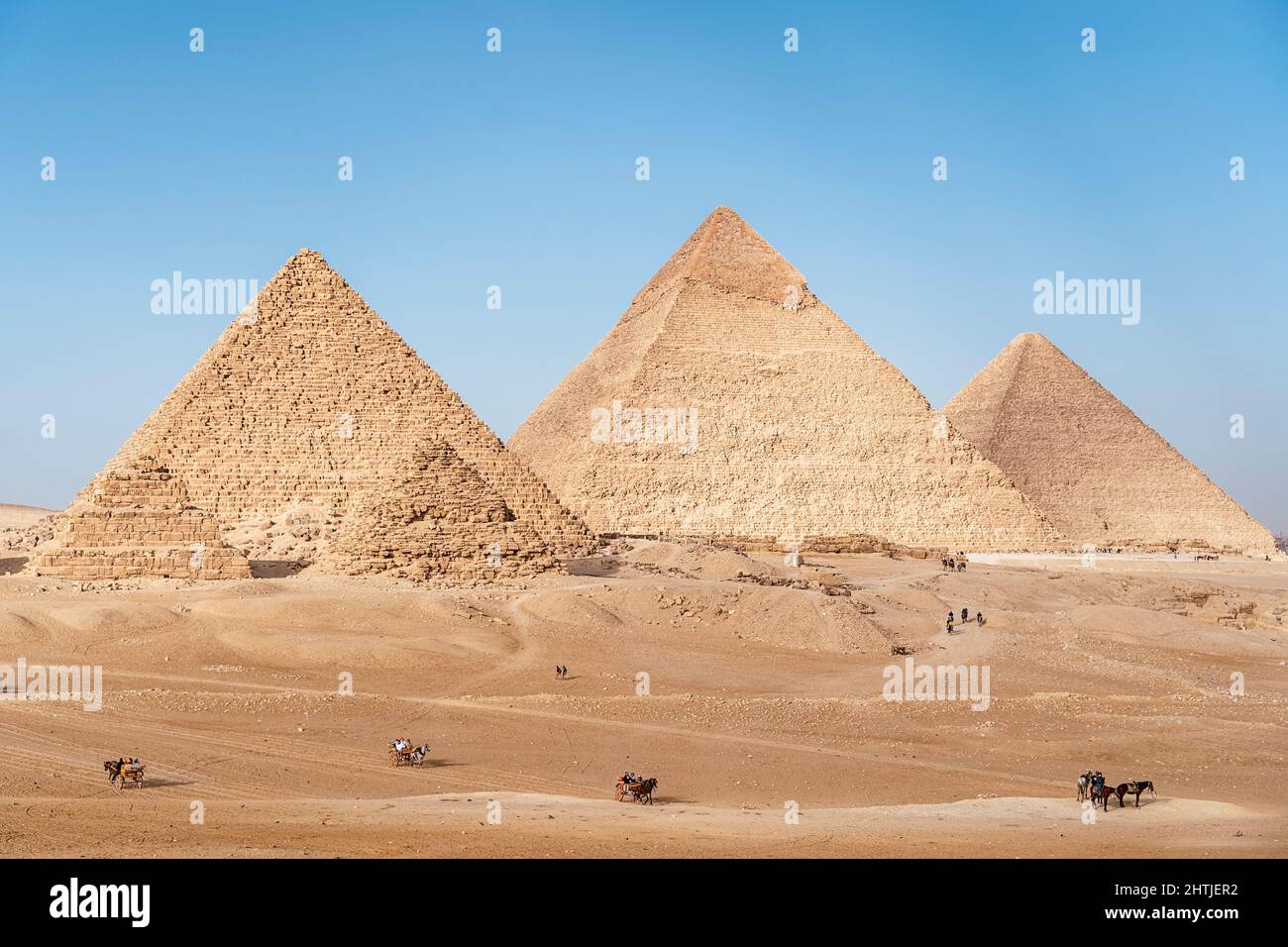 Tourist in ancient big Egyptian pyramids located on sandy terrain at ...