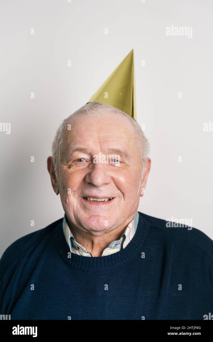 Side view of blond lady sitting on bed and browsing on tablet while ...