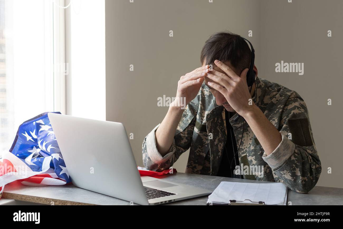 Happy army soldier having video call over laptop Stock Photo - Alamy