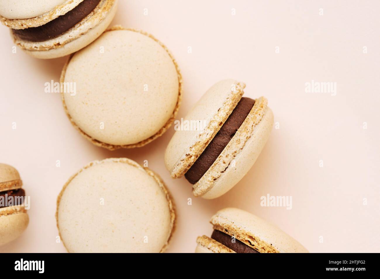 From above pile of coffee flavored macaroons with sweet filling served ...