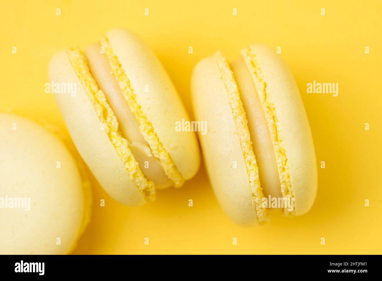 Sweet lemon flavored macarons with tasty filling served on yellow ...