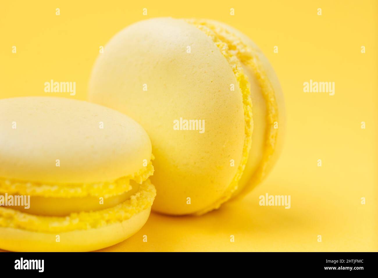 Sweet lemon flavored macarons with tasty filling served on yellow ...
