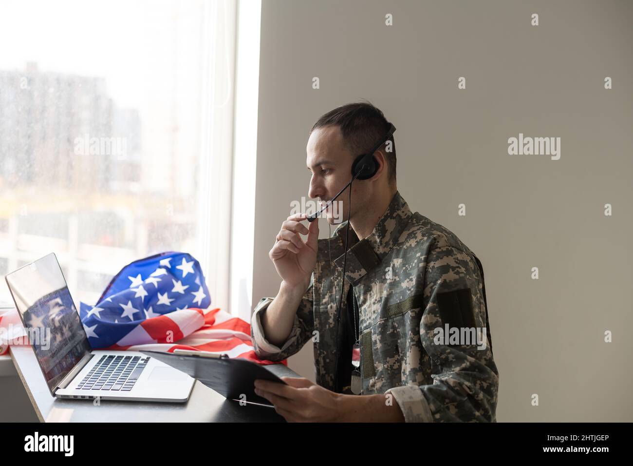 Happy army soldier having video call over laptop Stock Photo - Alamy
