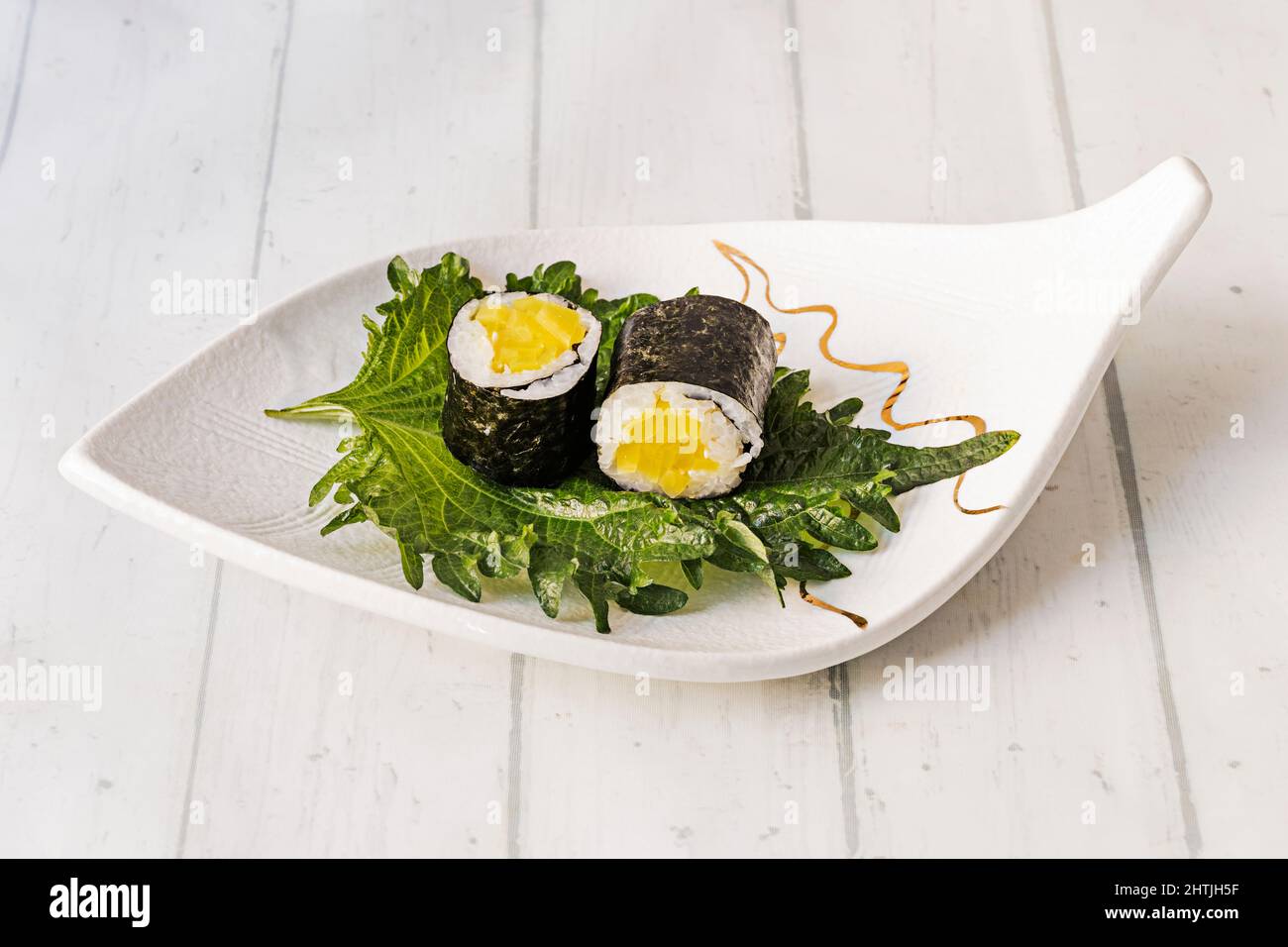 Two pieces of turnip-filled maki rolled with nori seaweed, Japanese ...