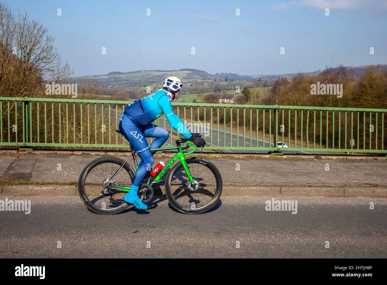 Male cyclist riding Planet X green sports road bike on countryside ...