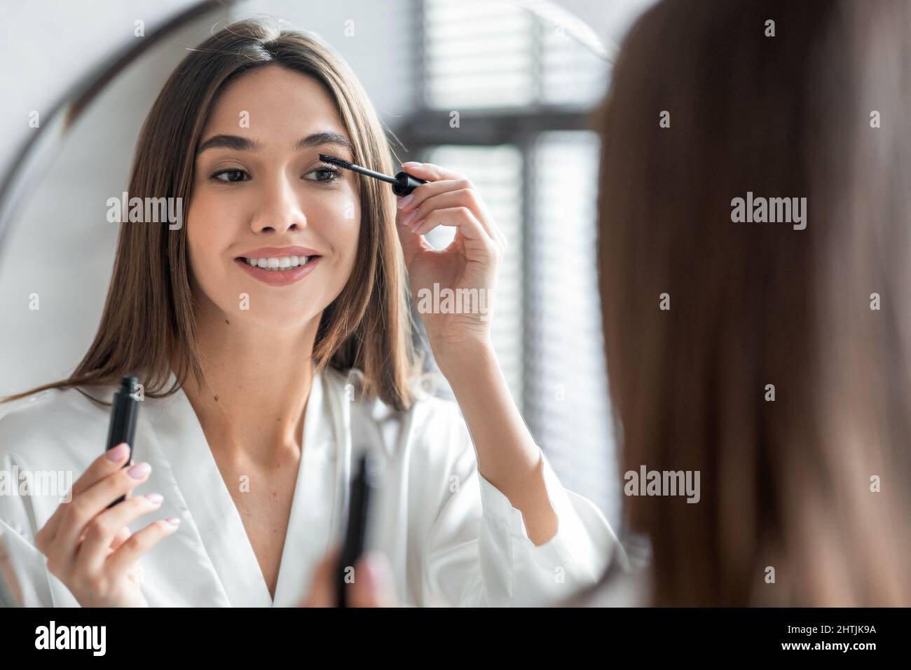 Makeup. Beautiful Young Woman Applying Mascara On Eyelashes, Getting ...