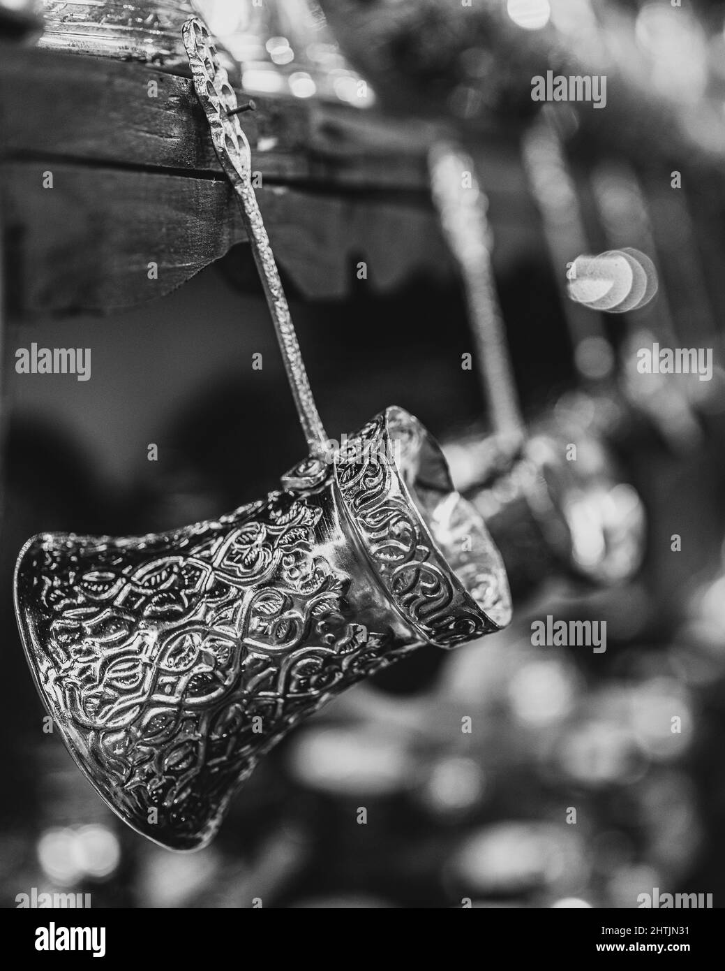 Vertical grayscale closeup of cezve. Turkish coffee pot, handmade ...