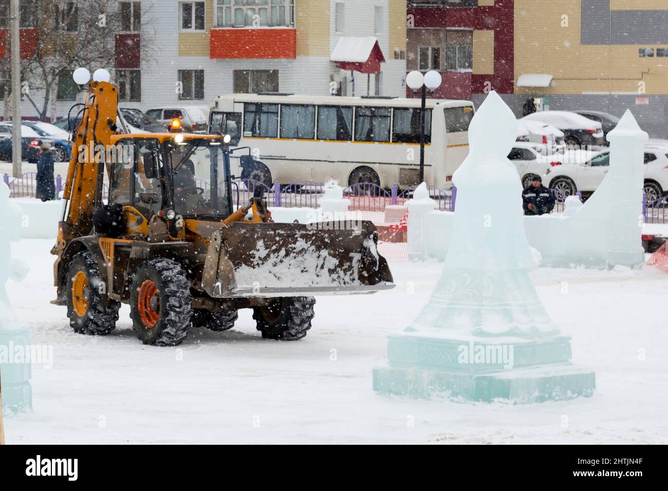 Construction worker clearing snow from the ice town Stock Photo - Alamy