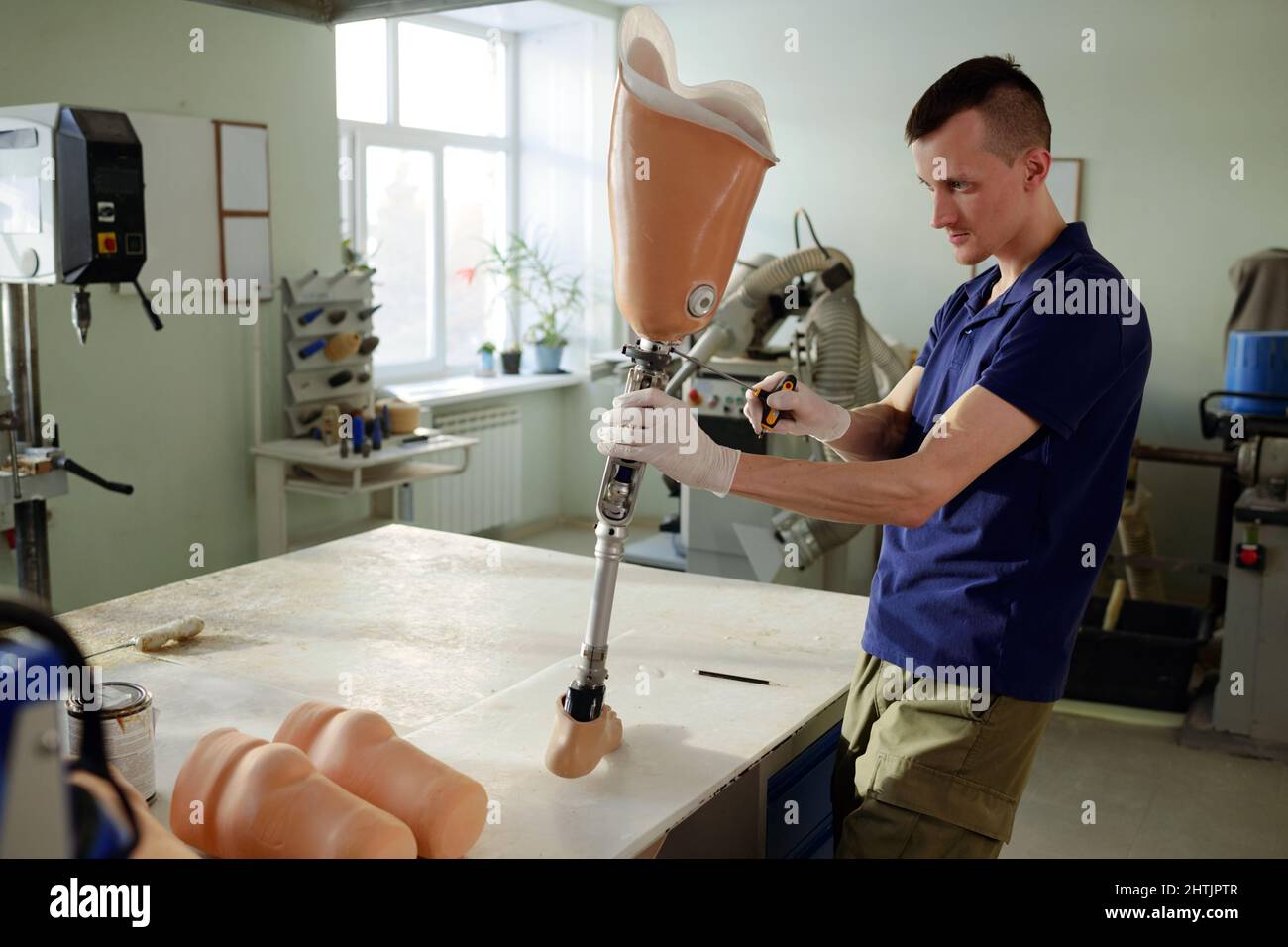 Worker of prosthetic production factory fixing socket covered with ...