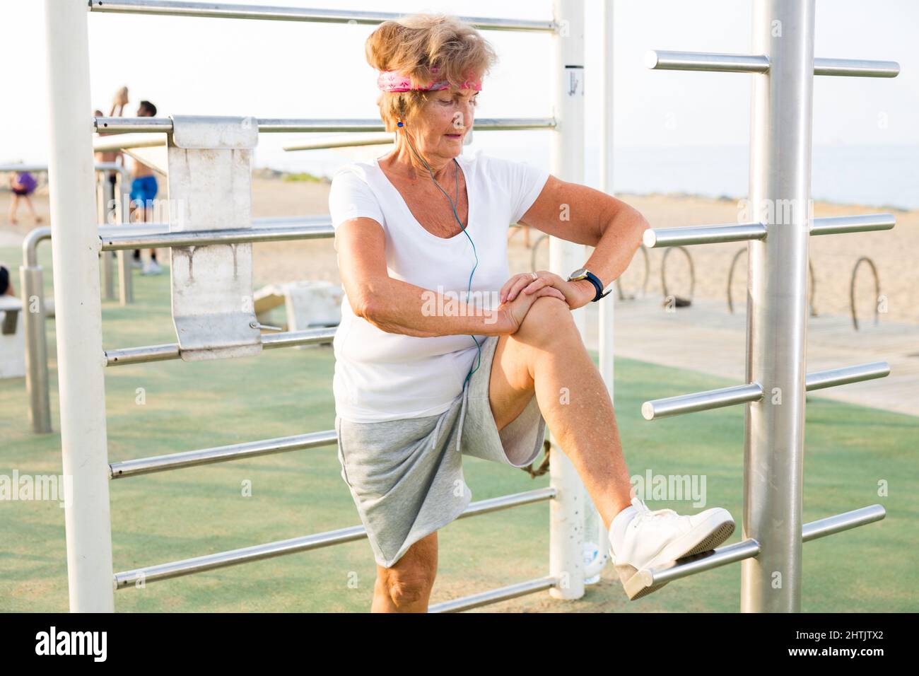 Old woman doing fitness exercises outdoors Stock Photo - Alamy