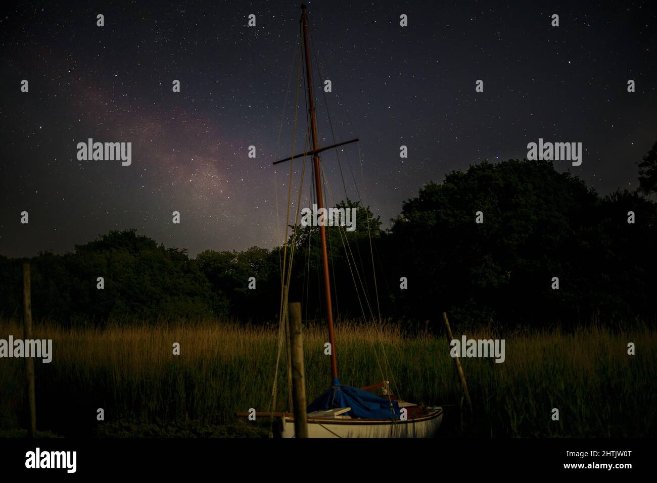 Boat on the riverside against the starry sky at night Stock Photo - Alamy