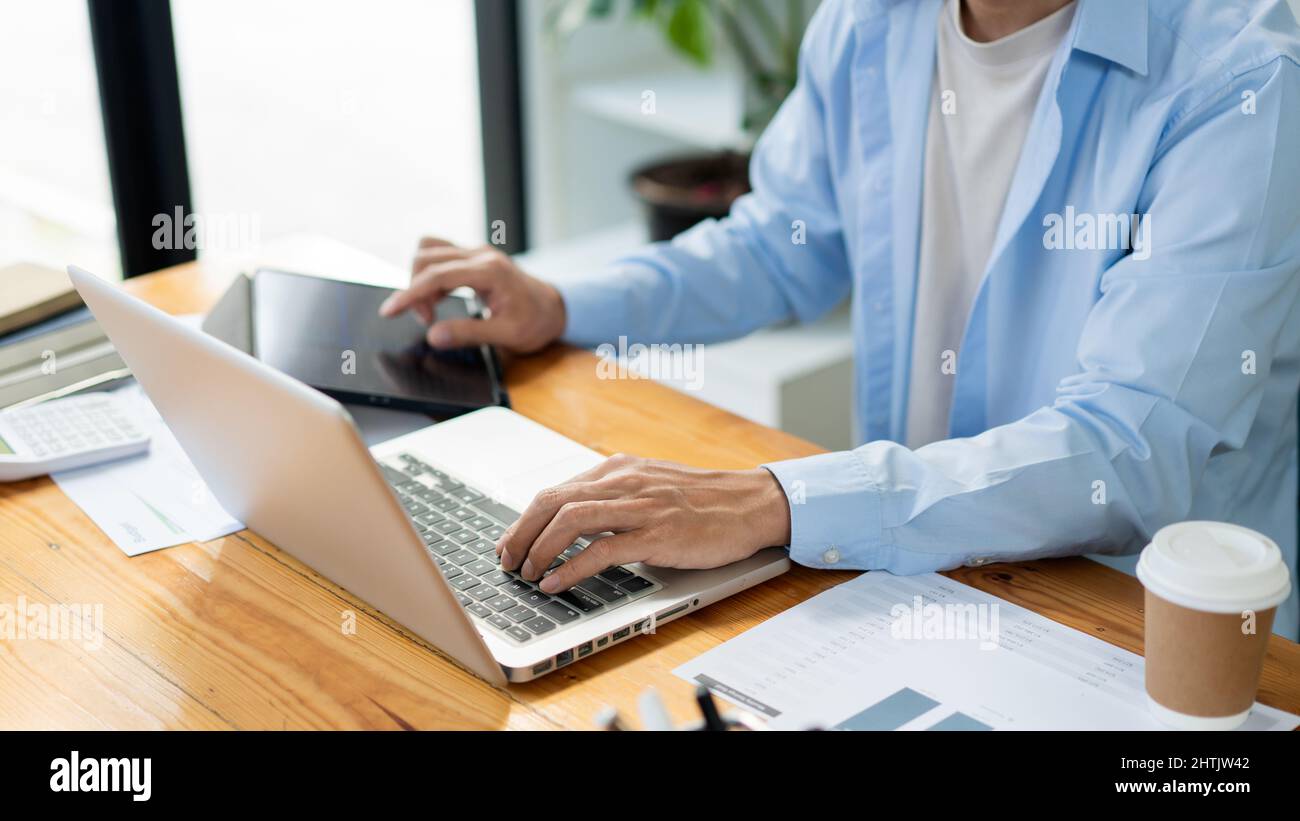 Business analyst concept the businessman using both computer laptop and ...