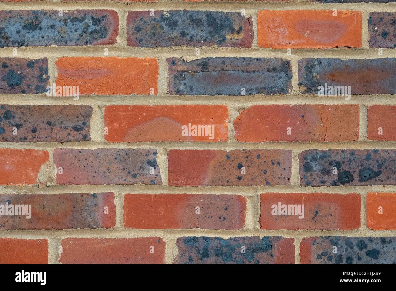 Close up section of mixed red brick wall, stretcher bond format Stock ...