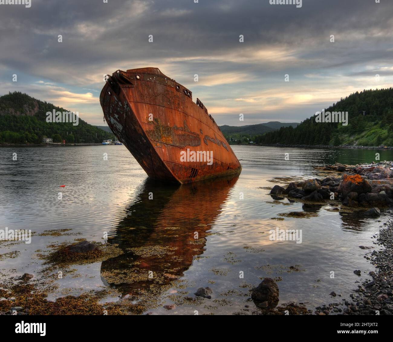 Abandoned rusty ship in the water Stock Photo - Alamy