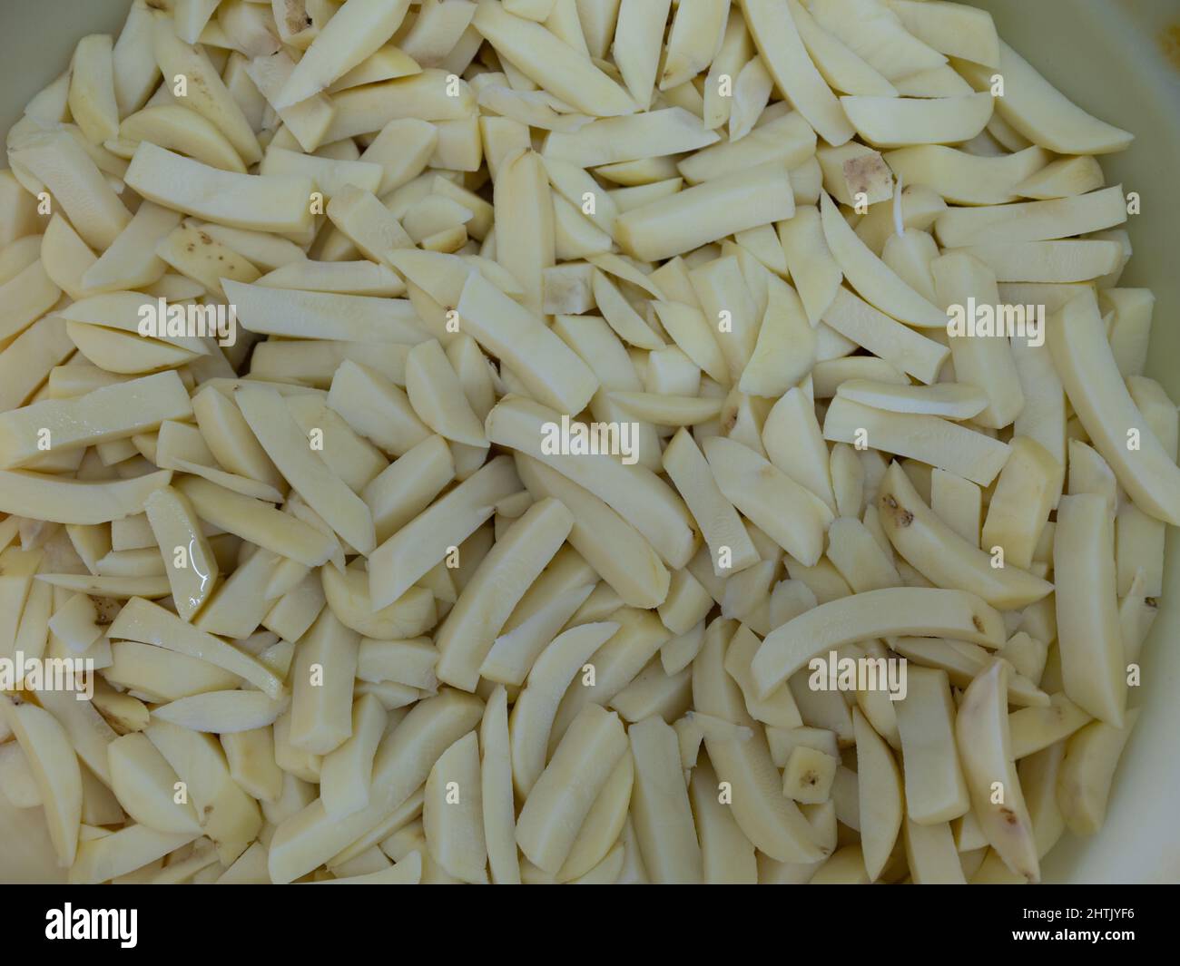 potatoes being chipped in an automatic chipper, at Compo's fish and ...
