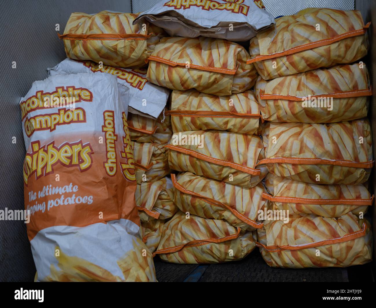 Bags of potatoes ready to be chipped in an automatic chipper, at Compo ...