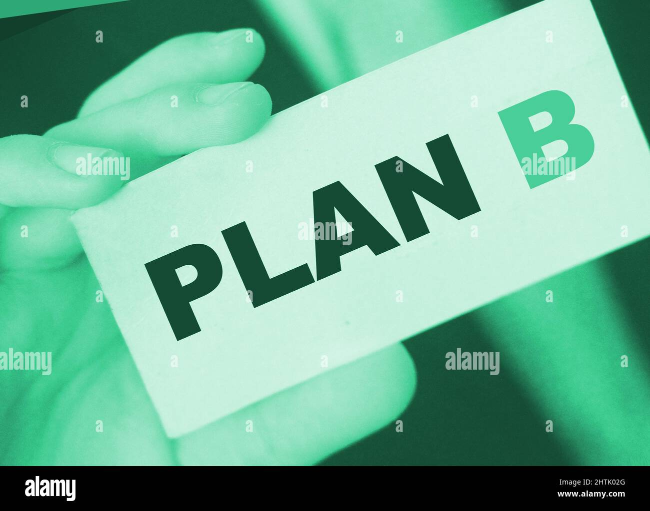 Plan B words on card in hand of businessman wearing suit and tie ...
