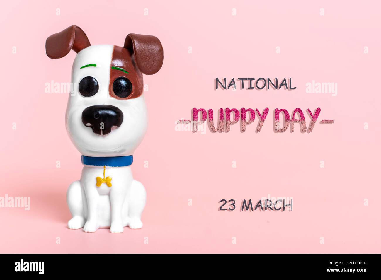 Cute toy small dog and text National puppy day 23 march isolated on ...