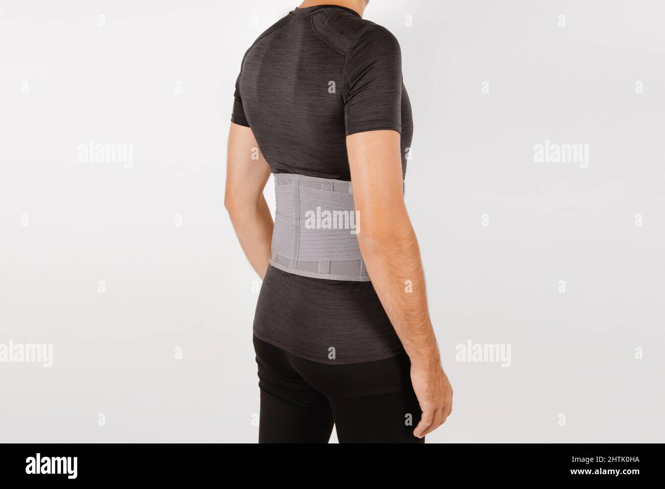 Lumbar brace on the human body isolated on a white background. Trauma ...