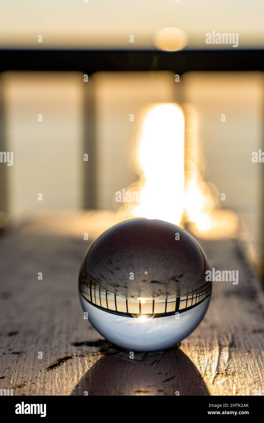 Crystal ball reflecting blurred sunset in a beach Stock Photo - Alamy