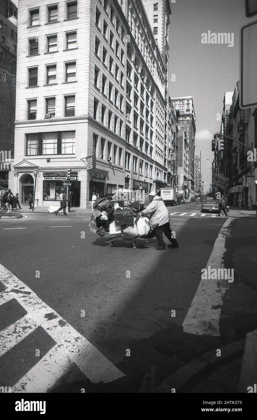 1980s, historical, a homeless man with his belongings loaded on a ...