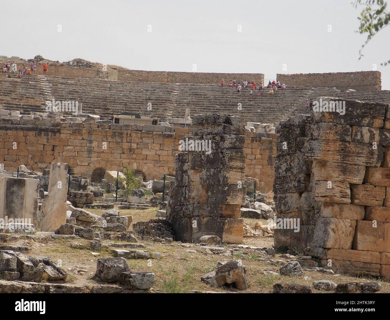 View of Bodrum Ancient Greek Theatre with people sitting on the stairs ...