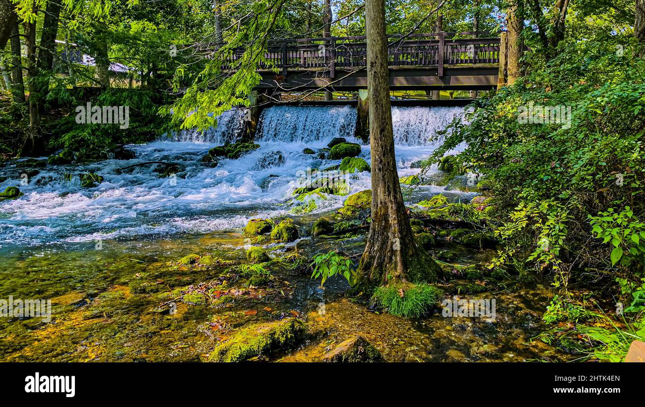 Beautiful landscape view of green grass, trees and a waterfall under a ...