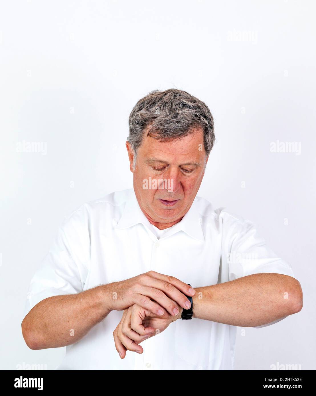 smart business man in white shirt looks at his arm watch with white ...