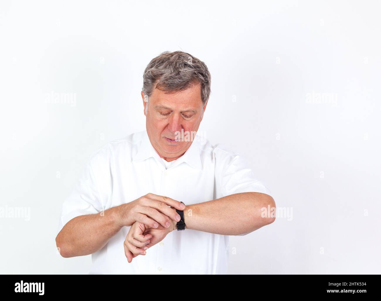 smart business man in white shirt looks at his arm watch with white ...