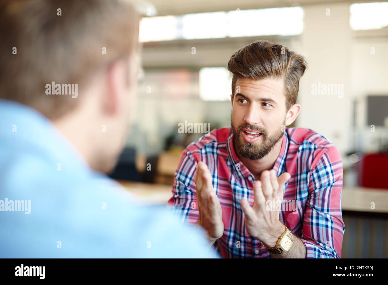 This is how I see it.... Shot of two colleagues discussing work in the ...