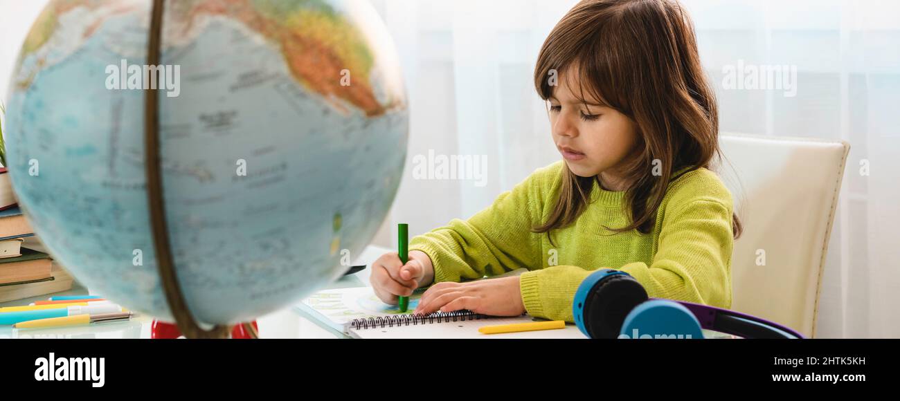 Horizontal banner or header with cute child girl doing homework at home ...