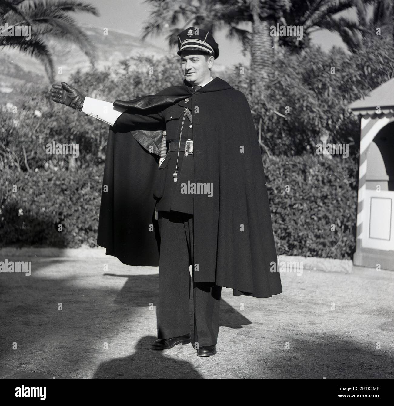 1950s, historical, uniformed Monaco policeman in cape and with whistle ...