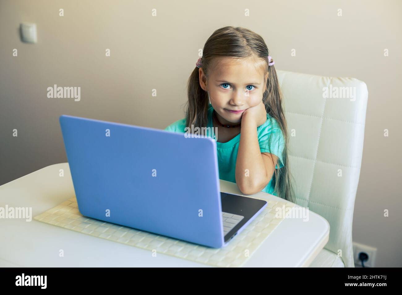 Little cute girl uses laptop to have video call Stock Photo - Alamy