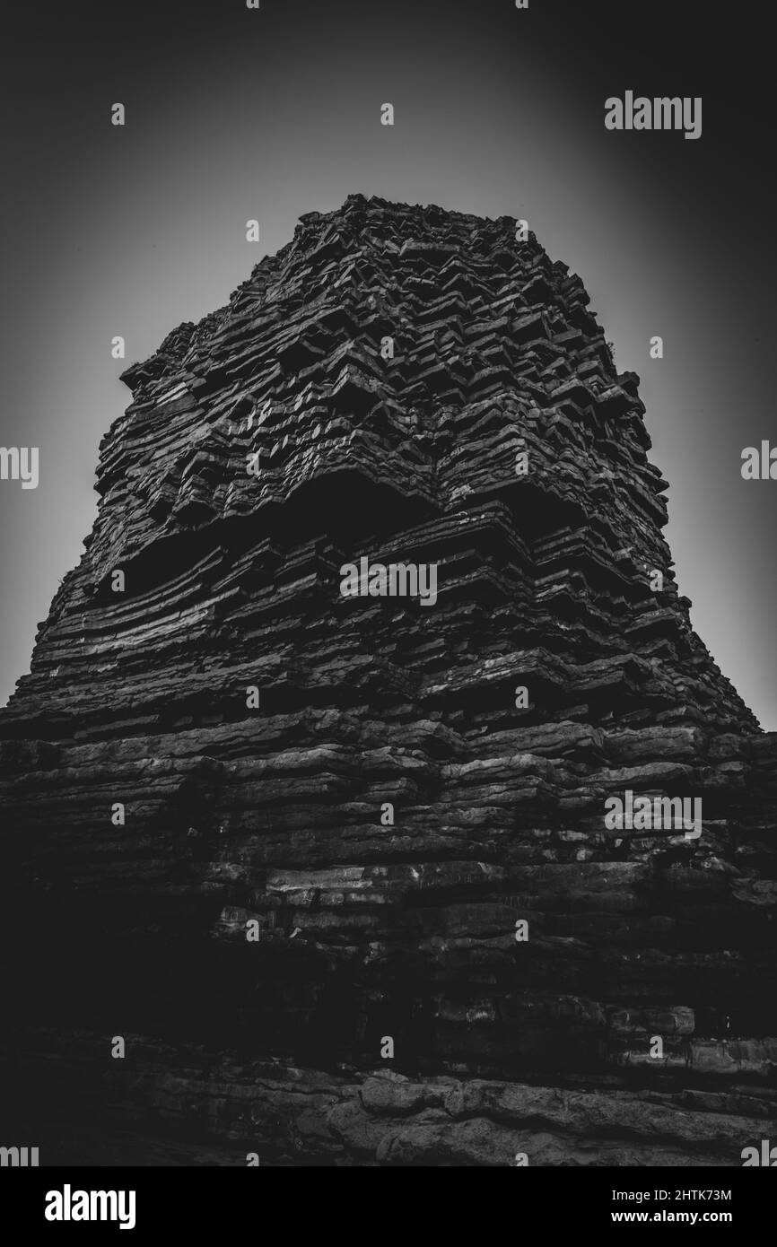Vertical grayscale shot of a hill rock Stock Photo - Alamy