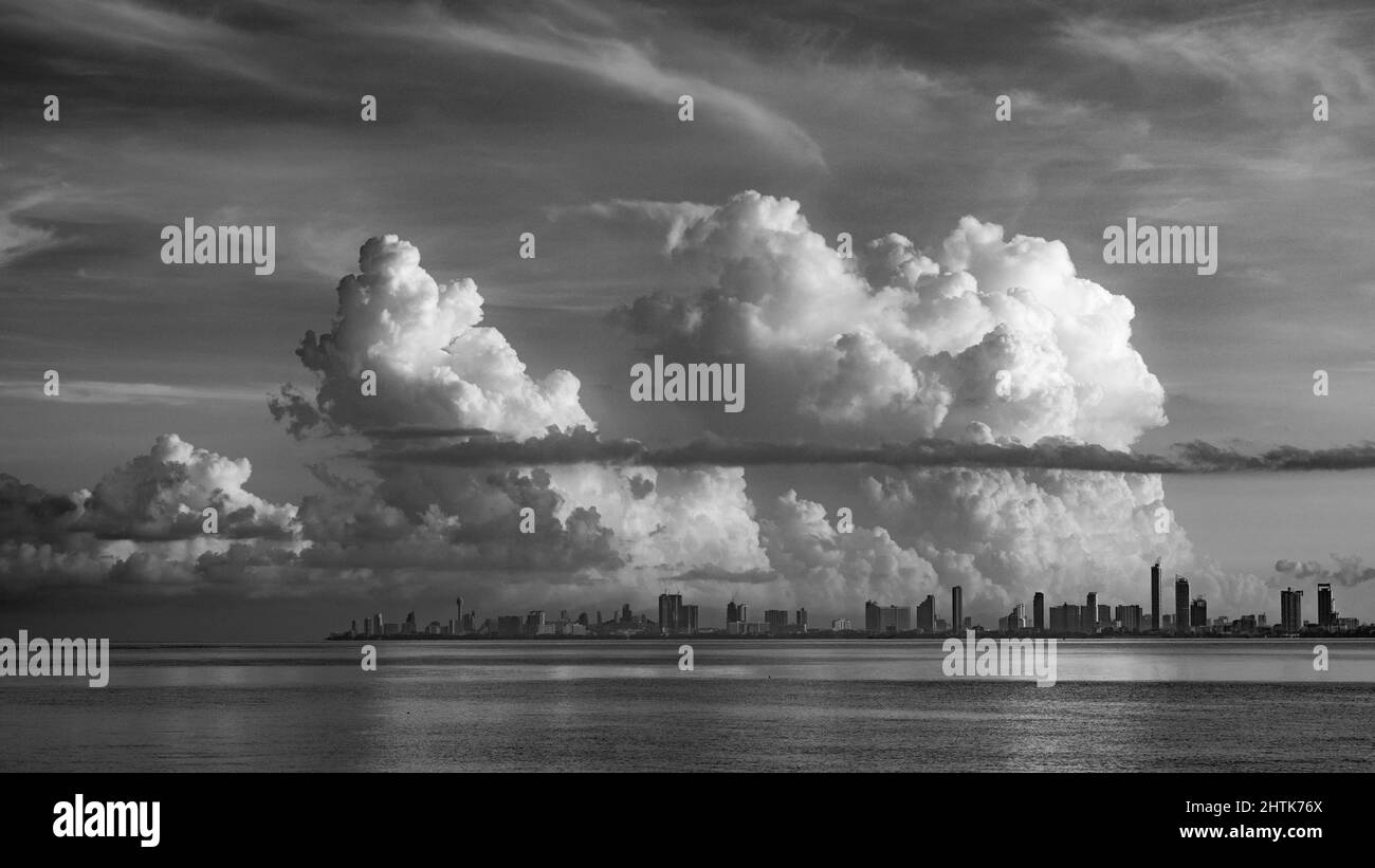 Distant view of the skyscrapers at the coastline and the clouds in ...