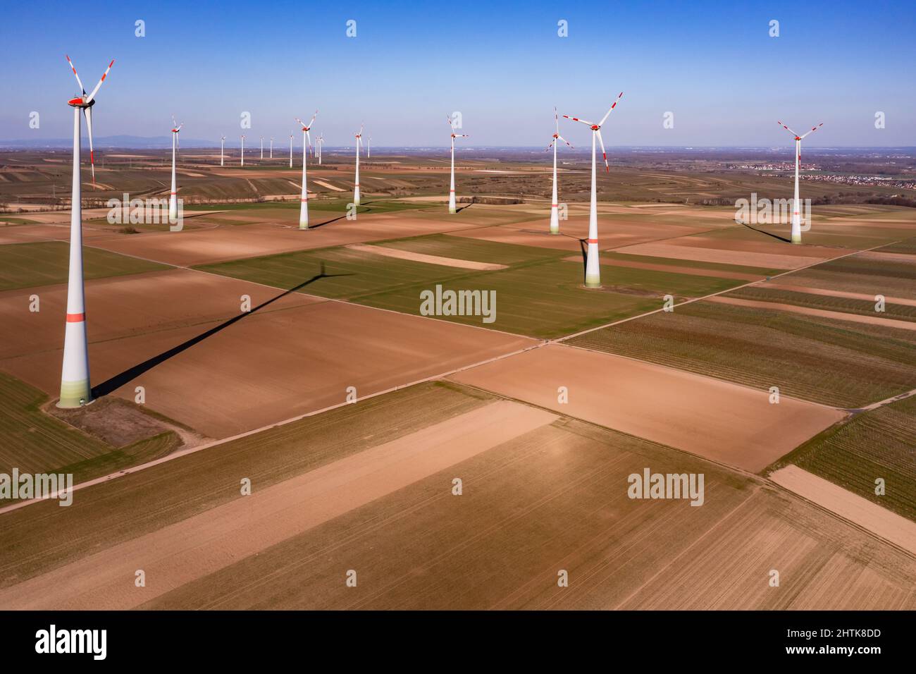 Aerial view of huge windmills between fields in sun in winter Stock ...