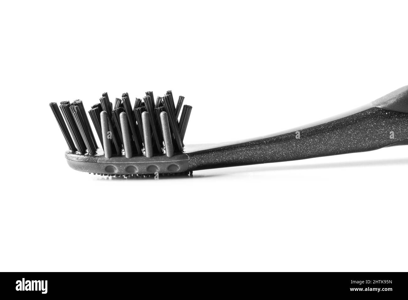 Black plastic toothbrush closeup isolated on white Stock Photo - Alamy