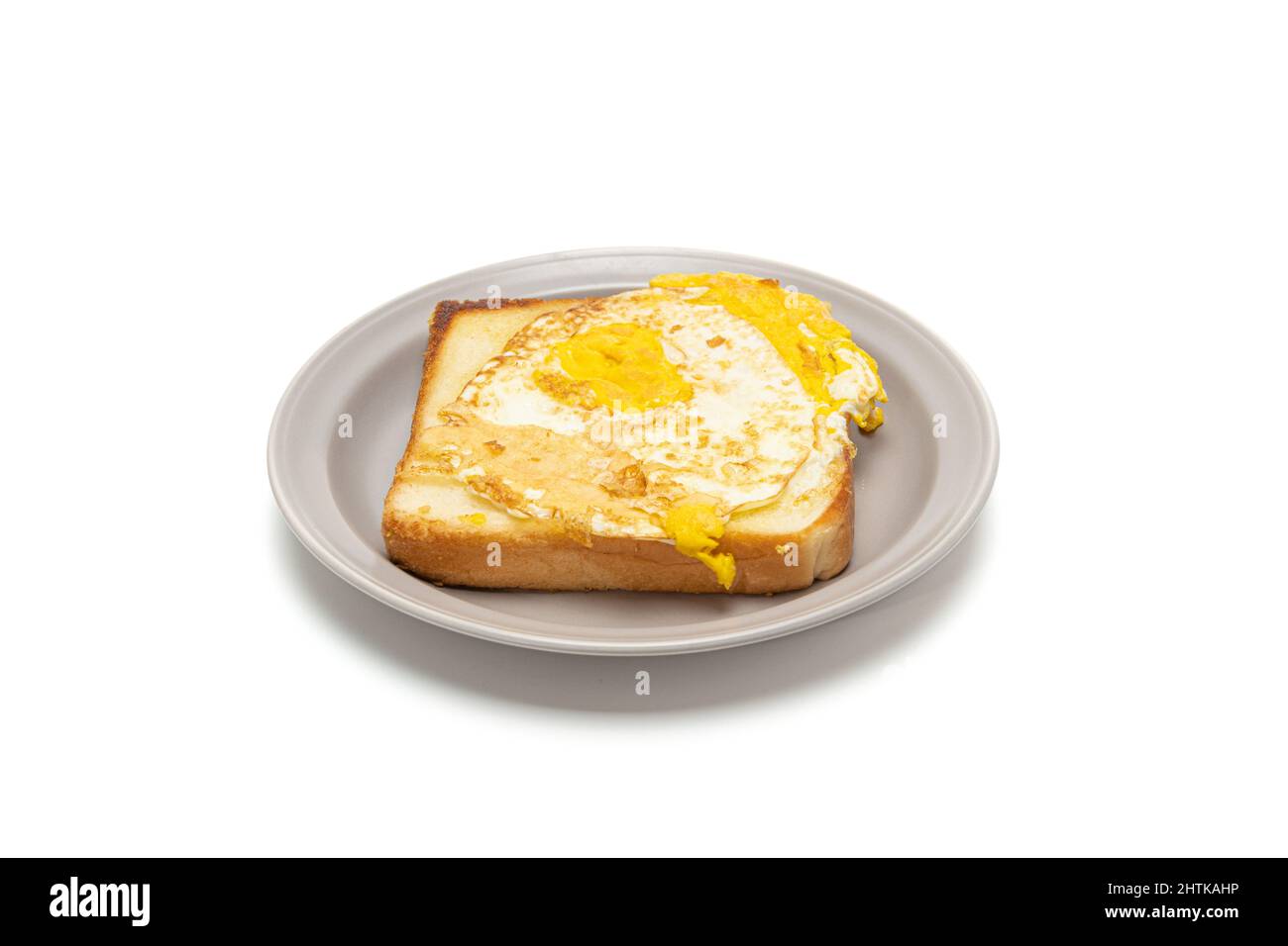 Toast made by pressing with white bread, breaking the yolk of a fried ...